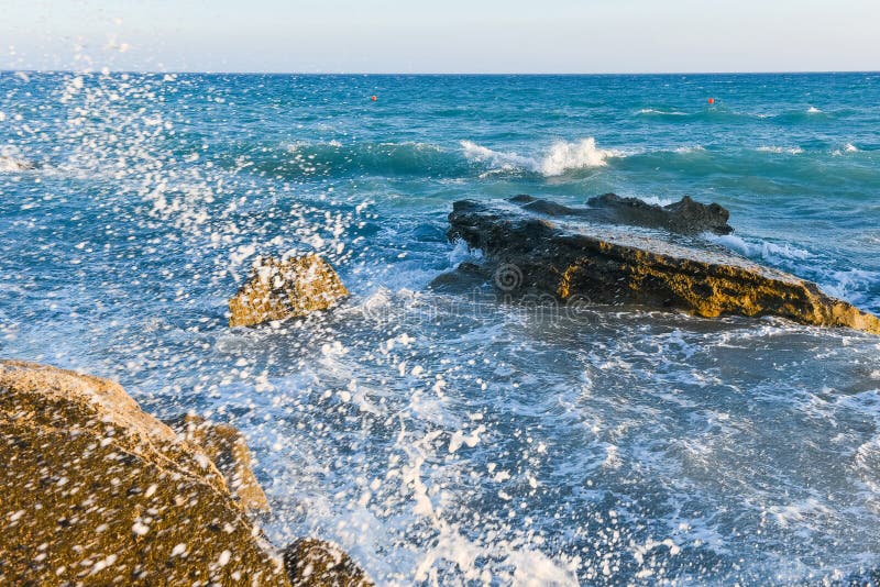 Sea waves and rocky beach stock image. Image of power - 119012093