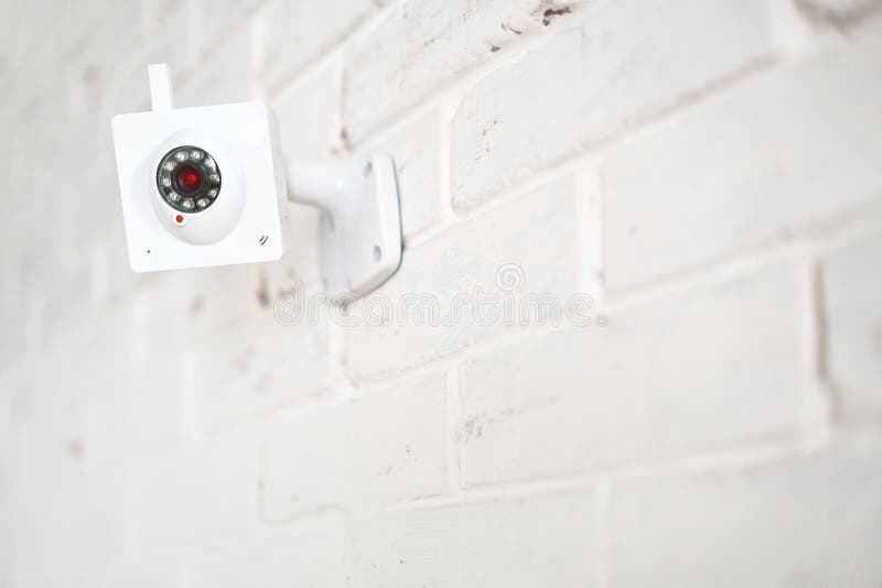 White Web Surveillance Camera on a White Brick Wall. Stock Photo ...