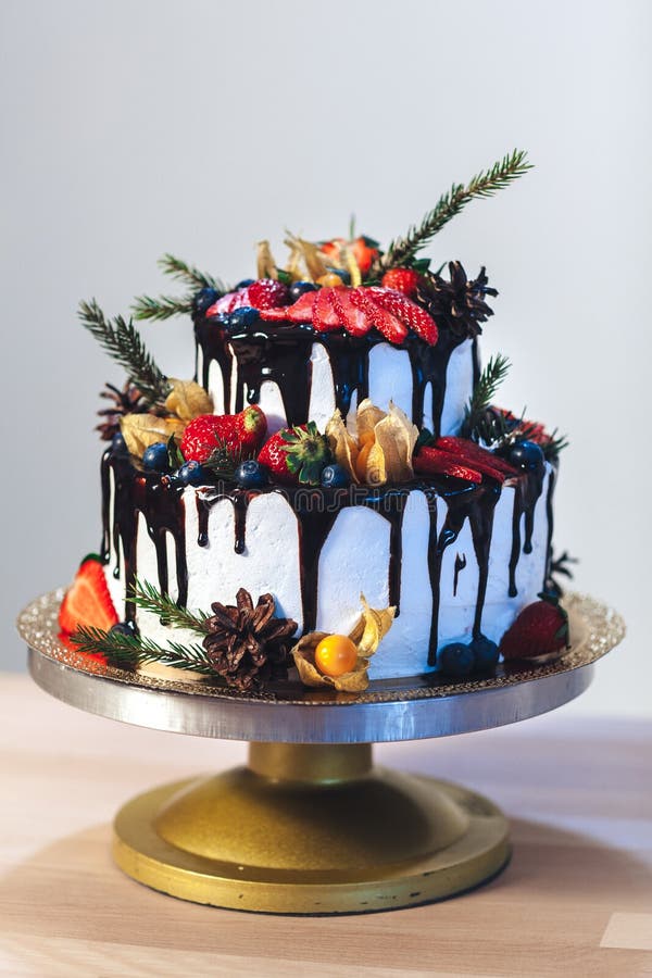 White Wedding Cake with Chocolate and Fruits on a Stand, Vertical Side ...