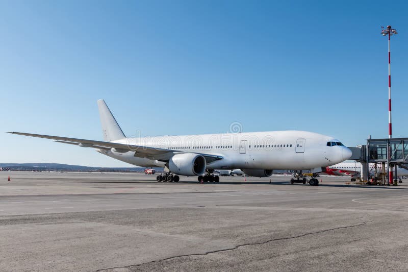 White Wide Body Passenger Plane at the Gateway on the Airport Stock ...