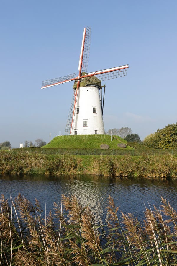 White windmill near river stock image. Image of europe - 24063871