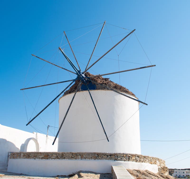 White Windmill on the Side of the Road Near a Building Stock Photo ...