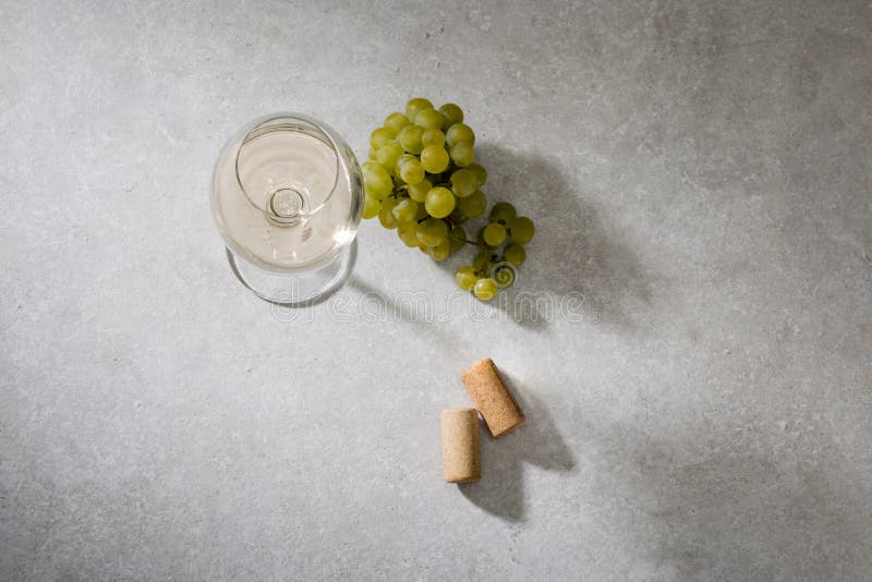 White Wine in a Glass and Corks on the Table Stock Photo - Image of ...
