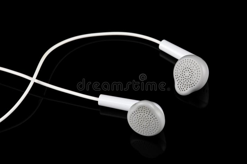 White Wired Earbuds on a Reflective Black Surface Stock Image - Image ...