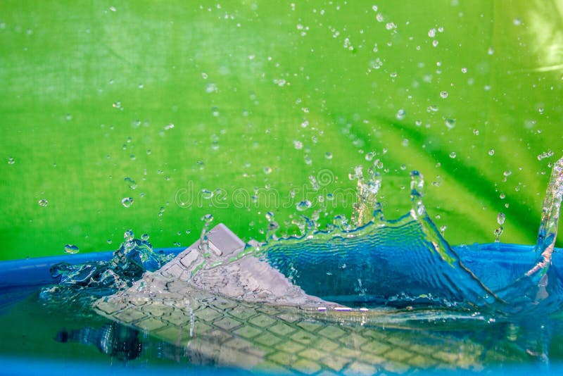 White Wireless Computer Keyboard Falling into the Water Spraying Stock ...