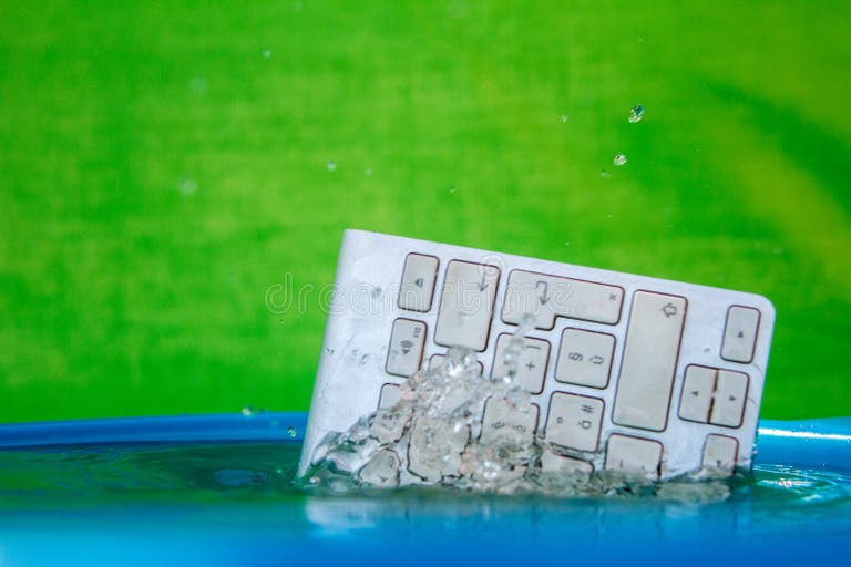 White Wireless Computer Keyboard Falling into the Water Spraying Stock ...