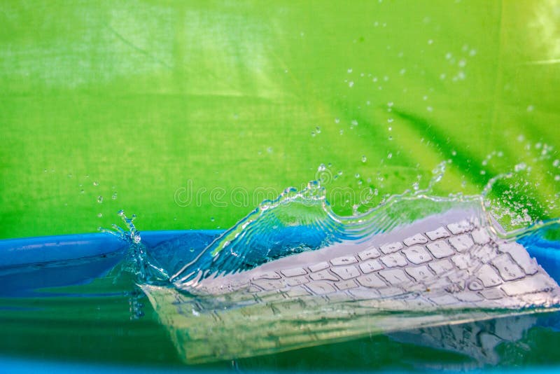 White Wireless Computer Keyboard Falling into the Water Spraying Stock ...