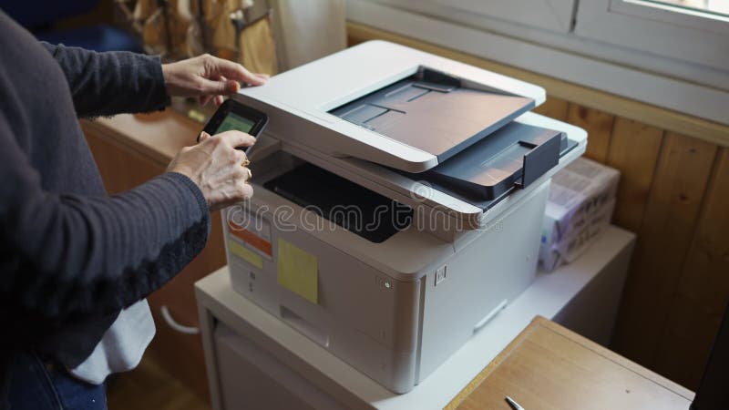 White Woman Making a Photocopy on a Printer while Teleworking at Home ...