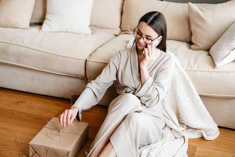 White Woman Talking on Mobile Phone while Sitting with Gift Box Stock ...