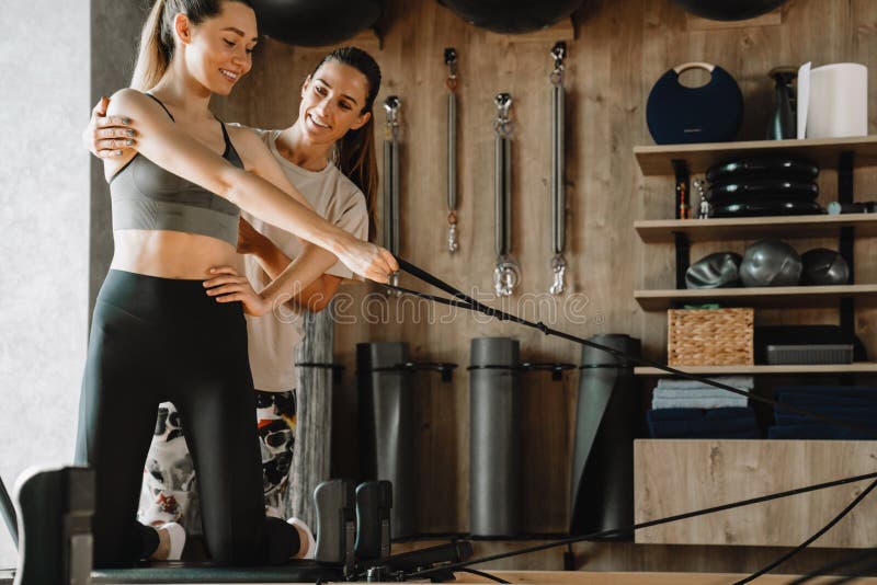 White Woman Working Out on Exercise Machine during Pilates Class Stock ...
