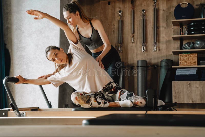 White Woman Working Out on Exercise Machine during Pilates Class Stock ...