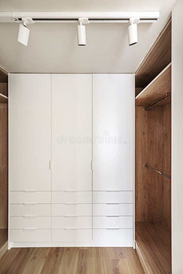 A White Wooden Cabinet Inside a Dressing Room with Lots of Drawers ...