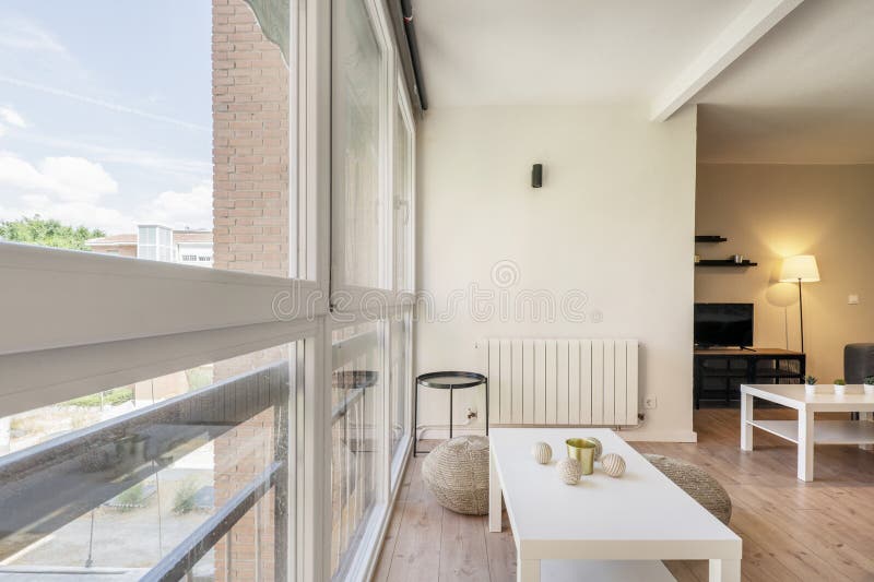 White Wooden Coffee Table Next To a Balcony with a View Stock Image ...