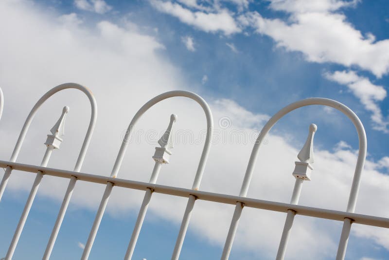 Corner of White Wrought Iron Fence Stock Photo - Image of post, clouds ...