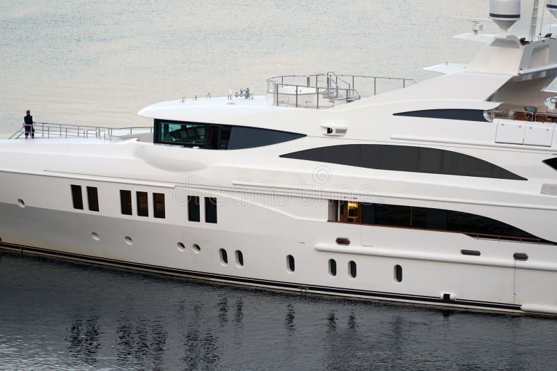 White Yacht with a Man on Deck in an Evening Bay Editorial Stock Image ...