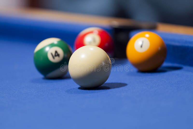 Orange, Green, Yellow and Red Billiard Balls in a Pool Table Stock ...