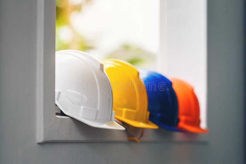 White, Yellow and Other Colored Safety Helmets for Workers` Safety ...