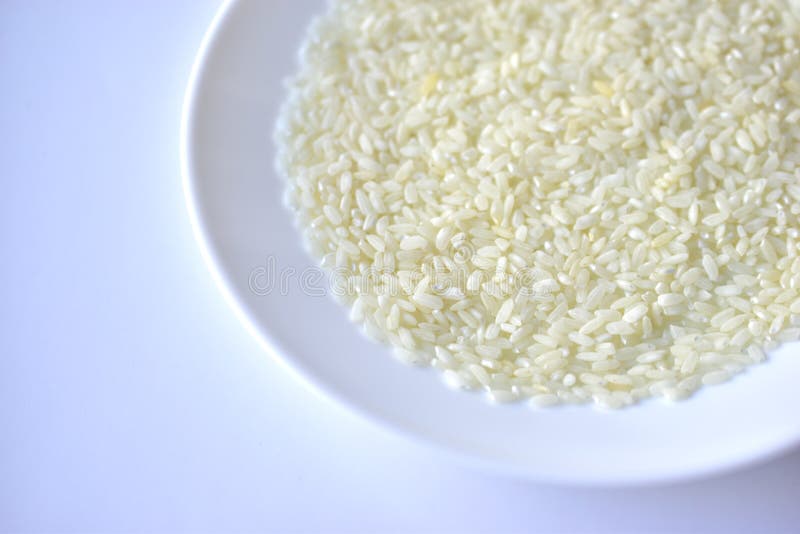 White Yellow Rice Grains on a White Plate Stock Photo - Image of asian ...