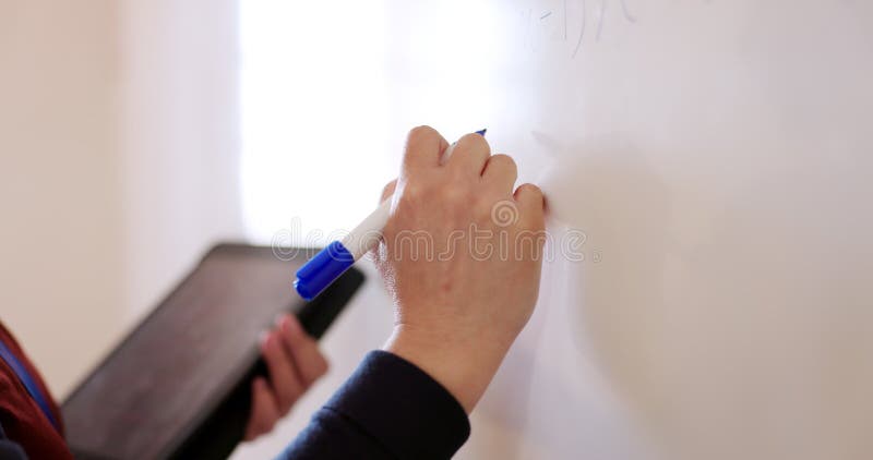 Whiteboard, Tablet and Teacher Hands Writing in a Classroom with ...