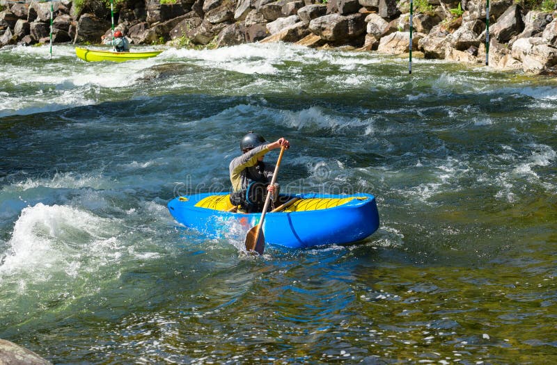 Blue canoe moving upstream stock image. Image of airbug - 125777749