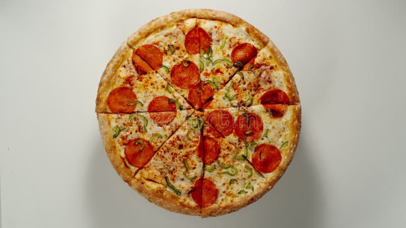 Whole Circle of Big Pizza is Rotating on a White Surface Stock Footage ...