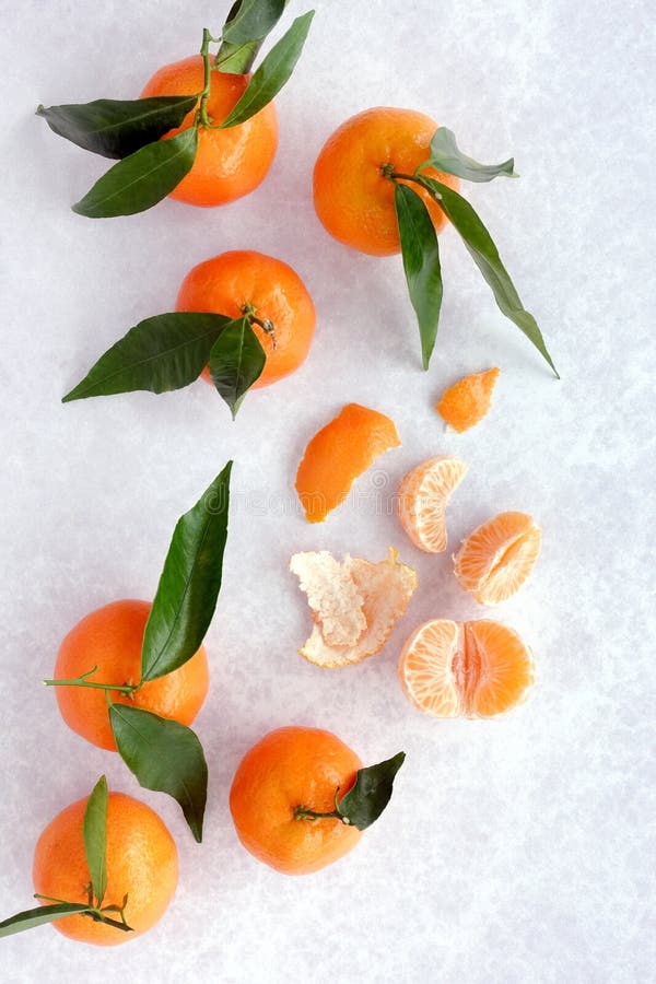 Whole Clementines with Leaves, Peel and Segments. Vertical Version ...