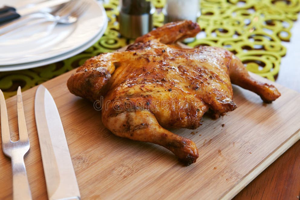 Whole Cooked Chicken with Cutlery and Spices Stock Photo - Image of ...