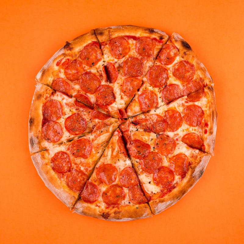 Whole, Cooked and Sliced Peperoni Pizza on a Bright Orange Background ...
