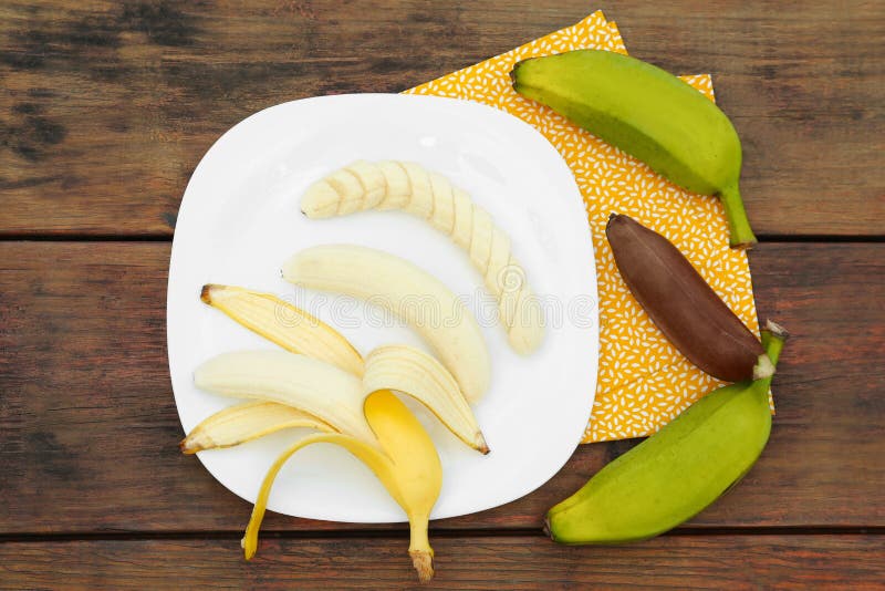 Whole and Cut Bananas on Wooden Table, Flat Lay Stock Photo - Image of ...