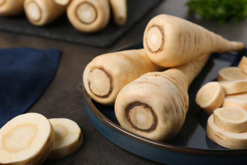 Whole and Cut Parsnips on Black Table, Closeup Stock Image - Image of ...