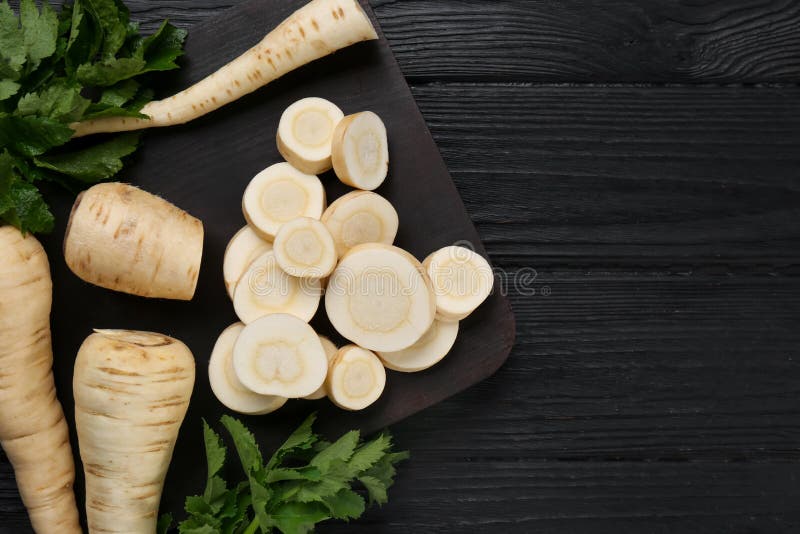 Whole and Cut Parsnips on Black Wooden Table, Flat Lay. Space for Text ...