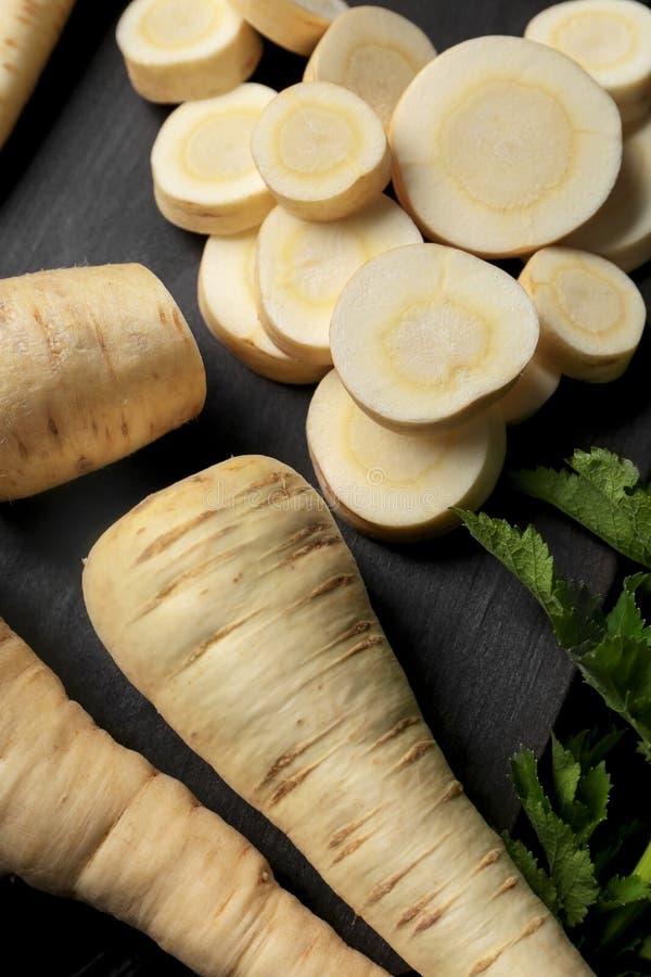 Whole and Cut Parsnips on Wooden Board, Above View Stock Photo - Image ...