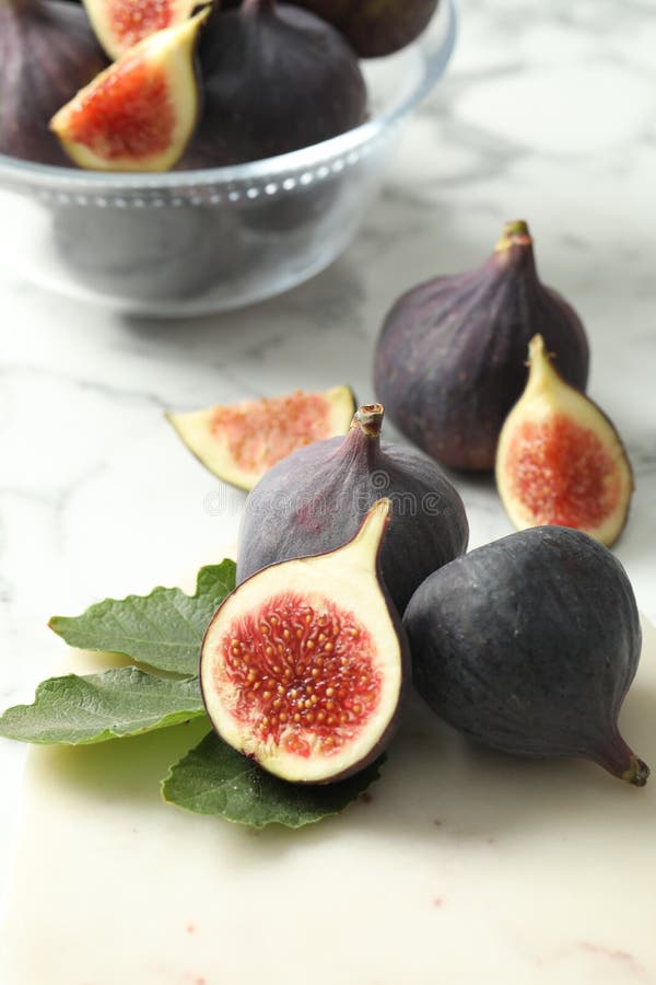 Whole and Cut Tasty Fresh Figs on White Marble Table Stock Image ...