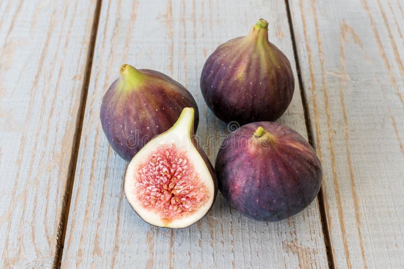 Whole Figs and One Fig Sliced in Half on Top of a Garden Table. Stock ...