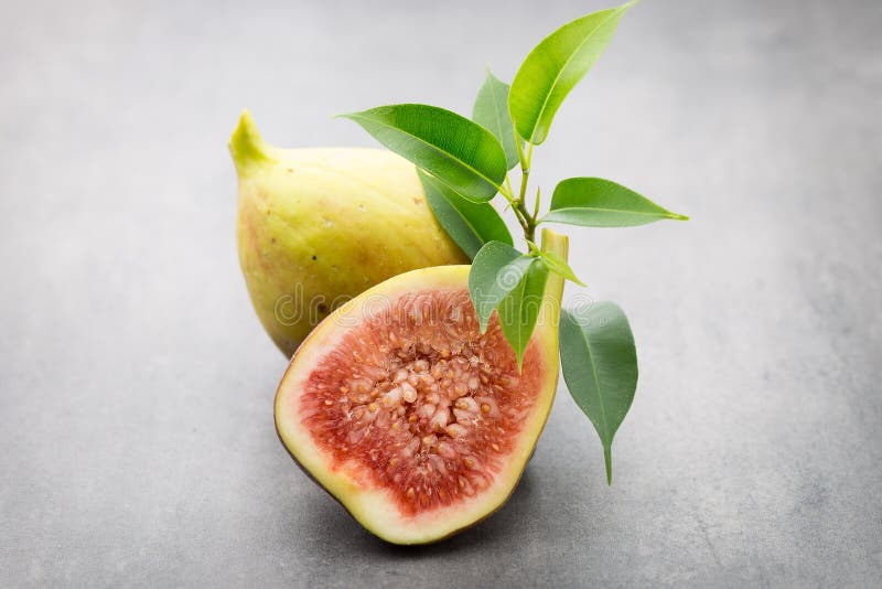 Whole Figs and One Fig Sliced in Half on Top of a Gray Table. Stock ...