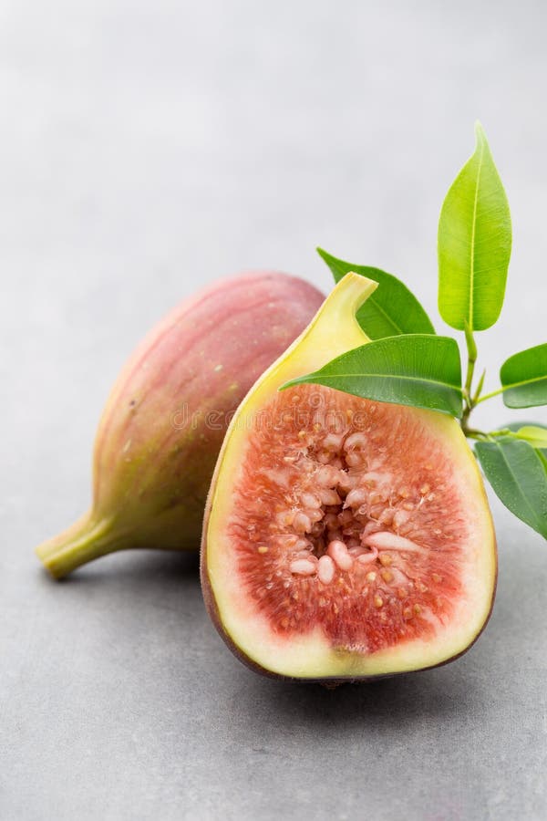 Whole Figs and One Fig Sliced in Half on Top of a Gray Table. Stock ...
