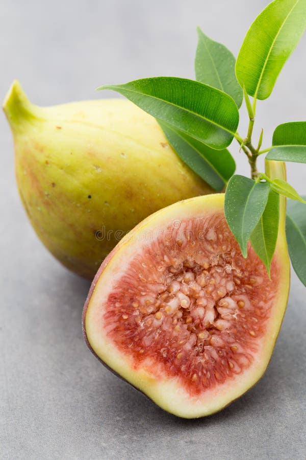 Whole Figs and One Fig Sliced in Half on Top of a Gray Table. Stock ...