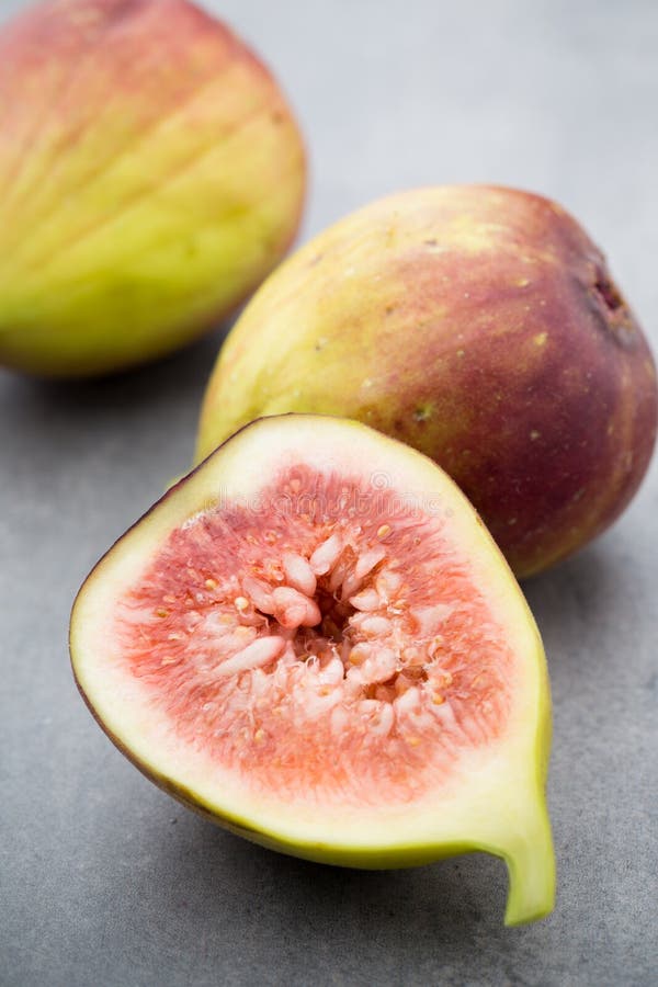 Whole Figs and One Fig Sliced in Half on Top of a Gray Table. Stock ...