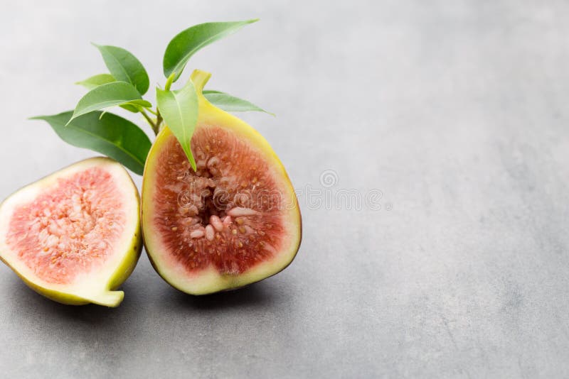 Whole Figs and One Fig Sliced in Half on Top of a Gray Table. Stock ...