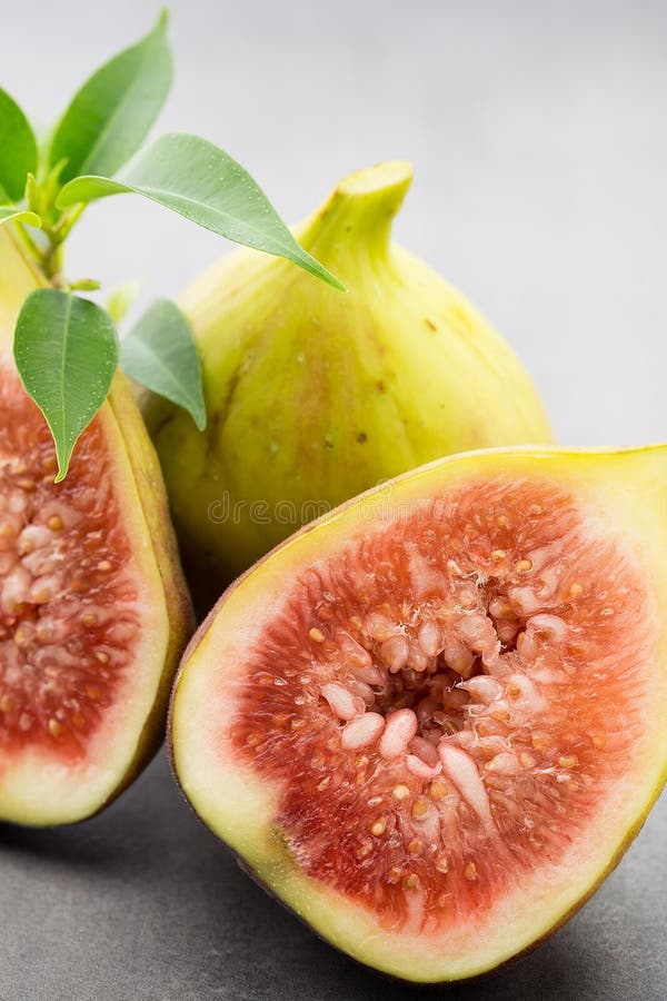 Whole Figs and One Fig Sliced in Half on Top of a Gray Table. Stock ...