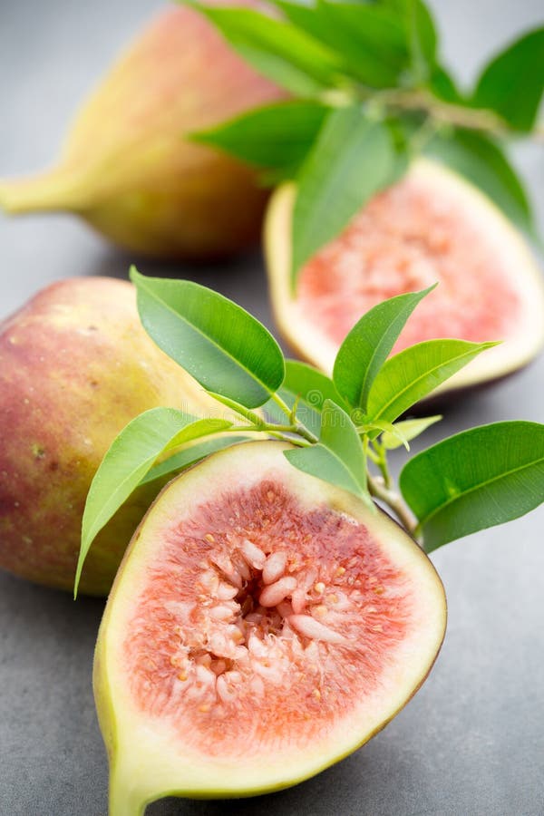 Whole Figs and One Fig Sliced in Half on Top of a Gray Table. Stock ...