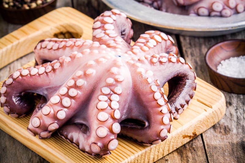 Whole Fresh Raw Octopus on Cutting Board with Sea Salt Stock Photo ...