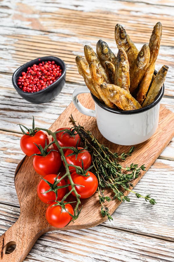 Whole Fried Capelin Fish Served on Cutting Board. White Background ...