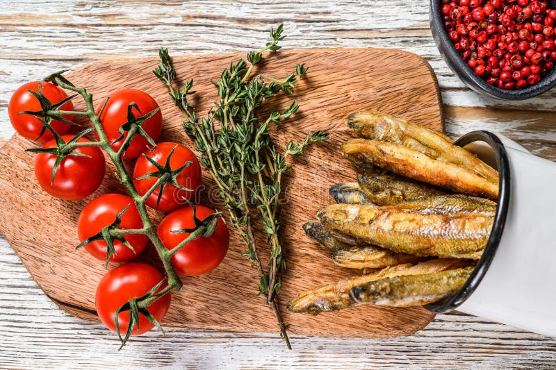 Whole Fried Capelin Fish Served on Cutting Board. White Background ...