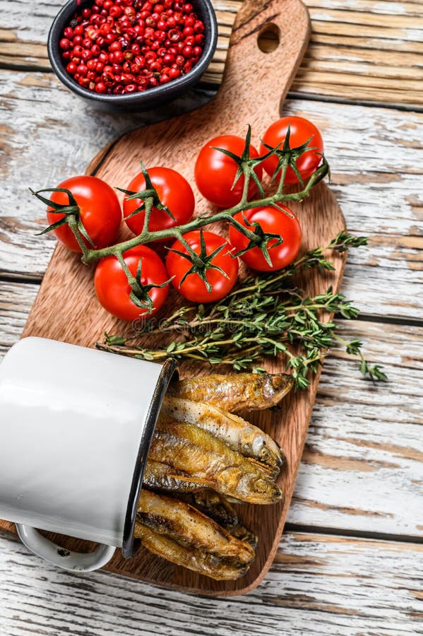 Whole Fried Capelin Fish Served on Cutting Board. White Background ...