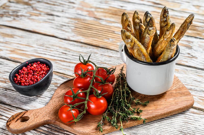 Whole Fried Capelin Fish Served on Cutting Board. White Background ...