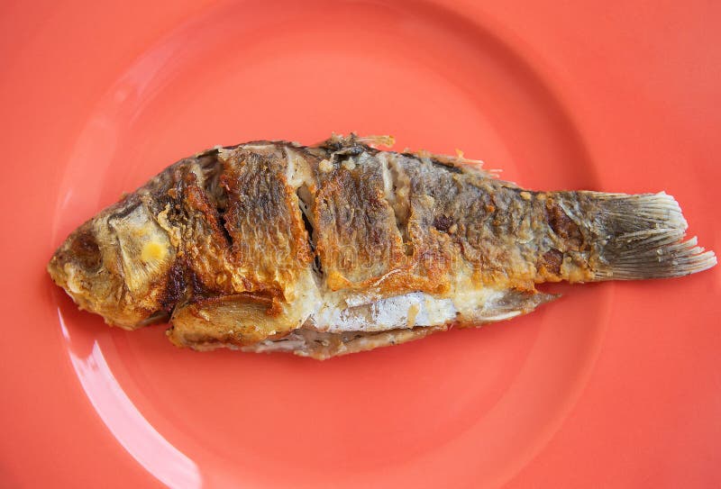 A Whole Fried Carp with a Fried Crust, Served on a Bright Red Plate ...
