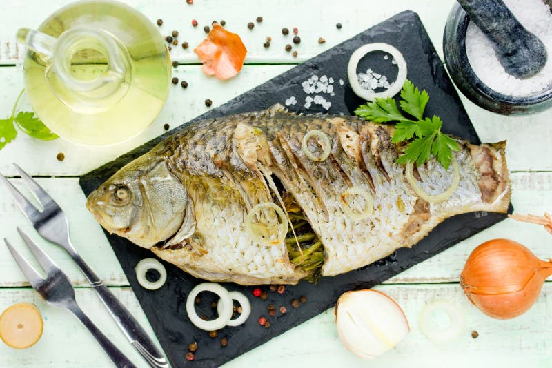 Whole Fried Fish on Kitchen Table with Ingredients Stock Photo - Image ...