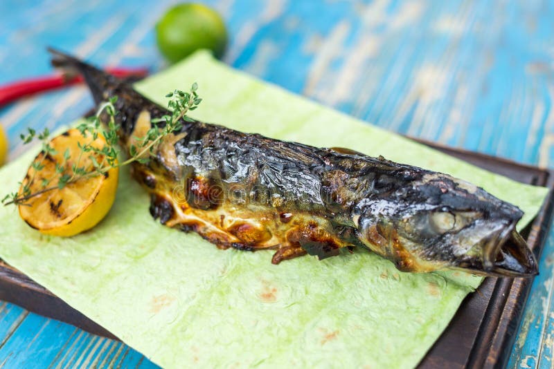 Whole Fried Fish on a Pita Bread Sheet Stock Photo - Image of ...