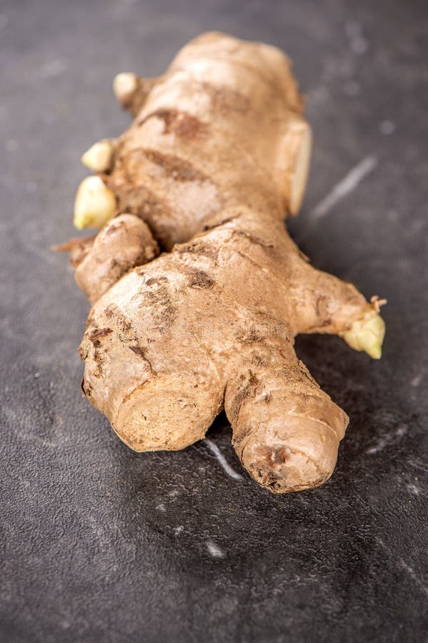 Whole Ginger Roots on Dark Old Stone Background Table, Space for Stock ...